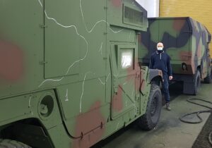 U.S. Army repainting its military vehicles with green paint for camouflage